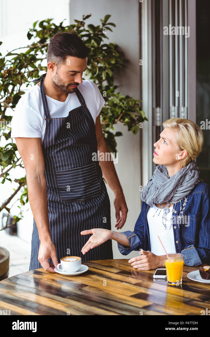 Pretty blonde arguing with the waiter Stock Photo - Alamy