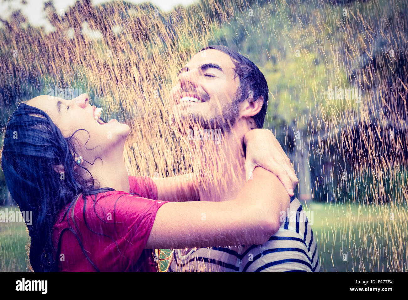 Cute couple hugging under the rain Stock Photo - Alamy