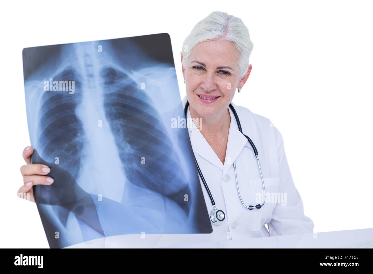 Serious smiling doctor looking at x-ray Stock Photo - Alamy