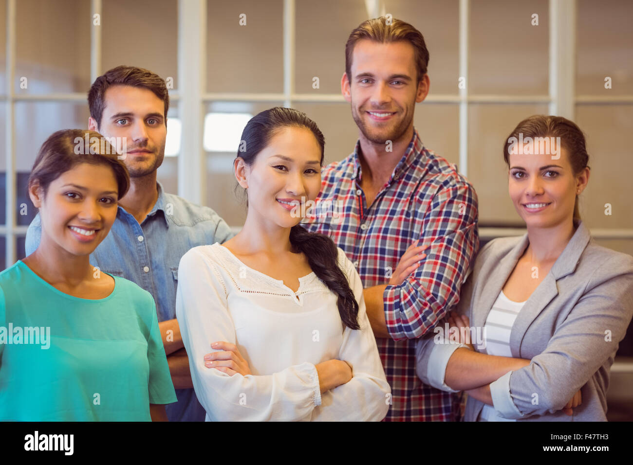 Creative business team looking at the camera Stock Photo - Alamy