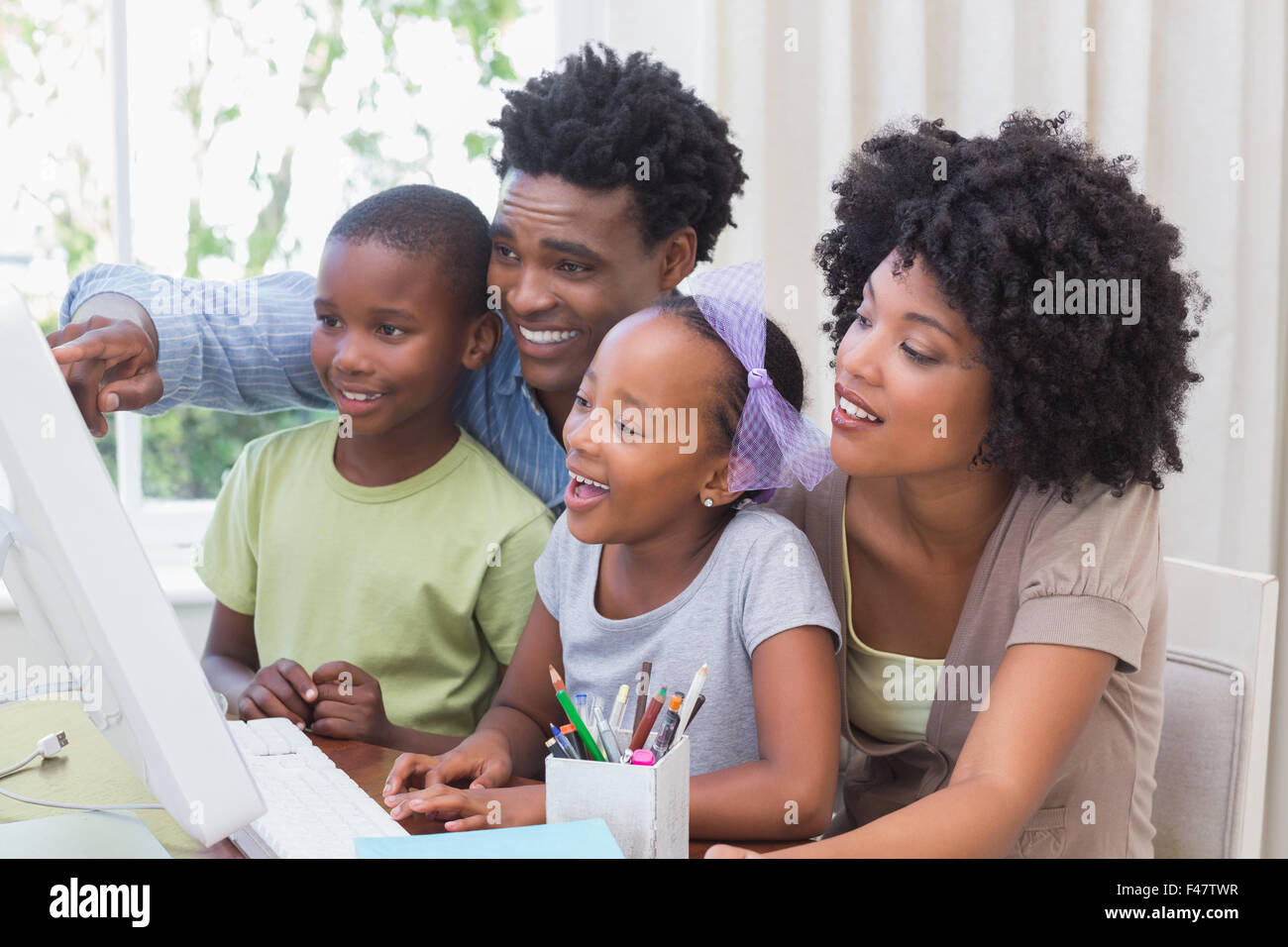 Happy family using the computer Stock Photo - Alamy