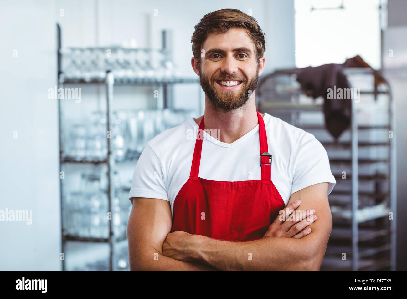 Handsome barista smiling at the camera Stock Photo - Alamy
