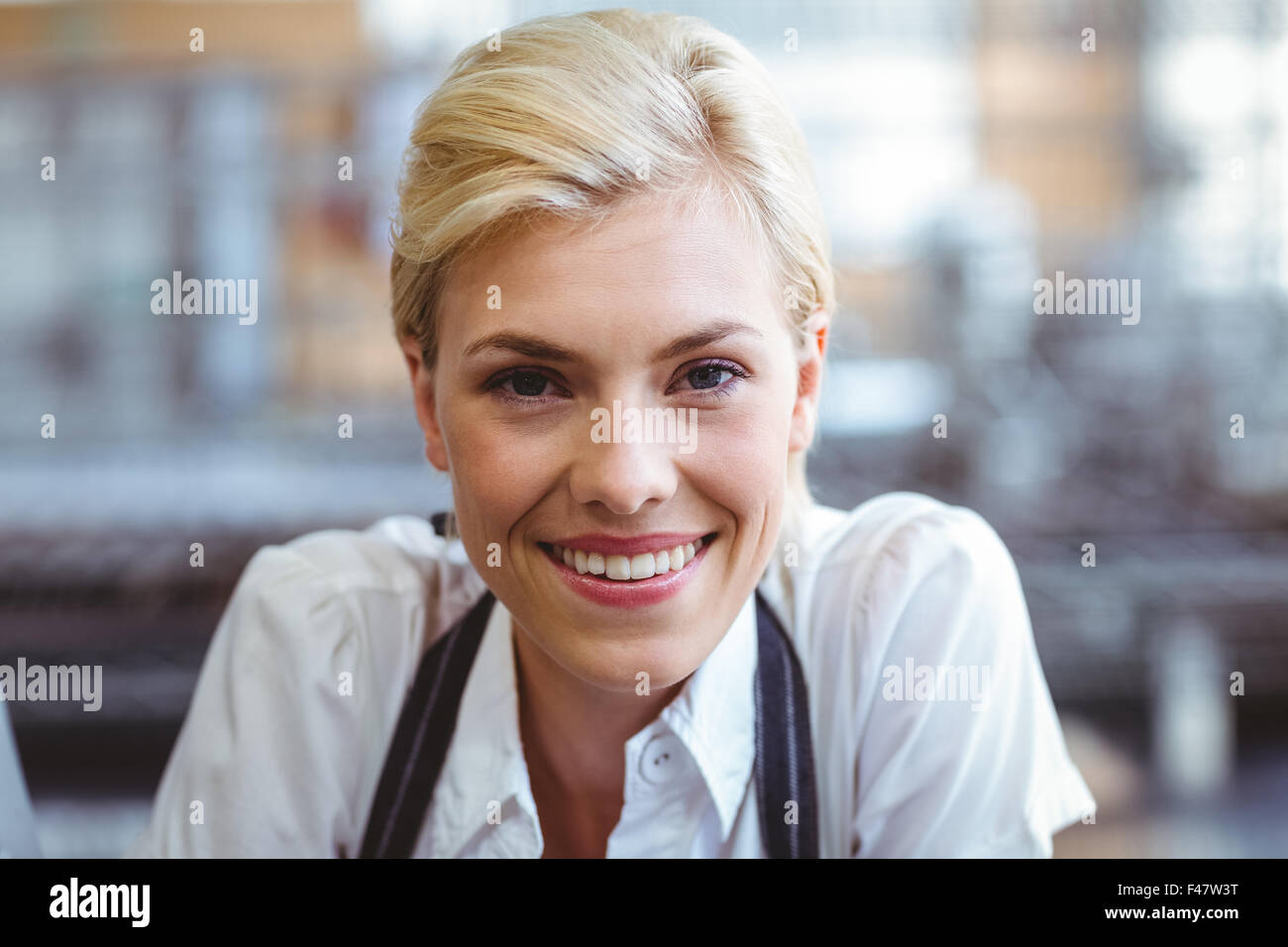 Selfassured female waitress smiling Stock Photo - Alamy