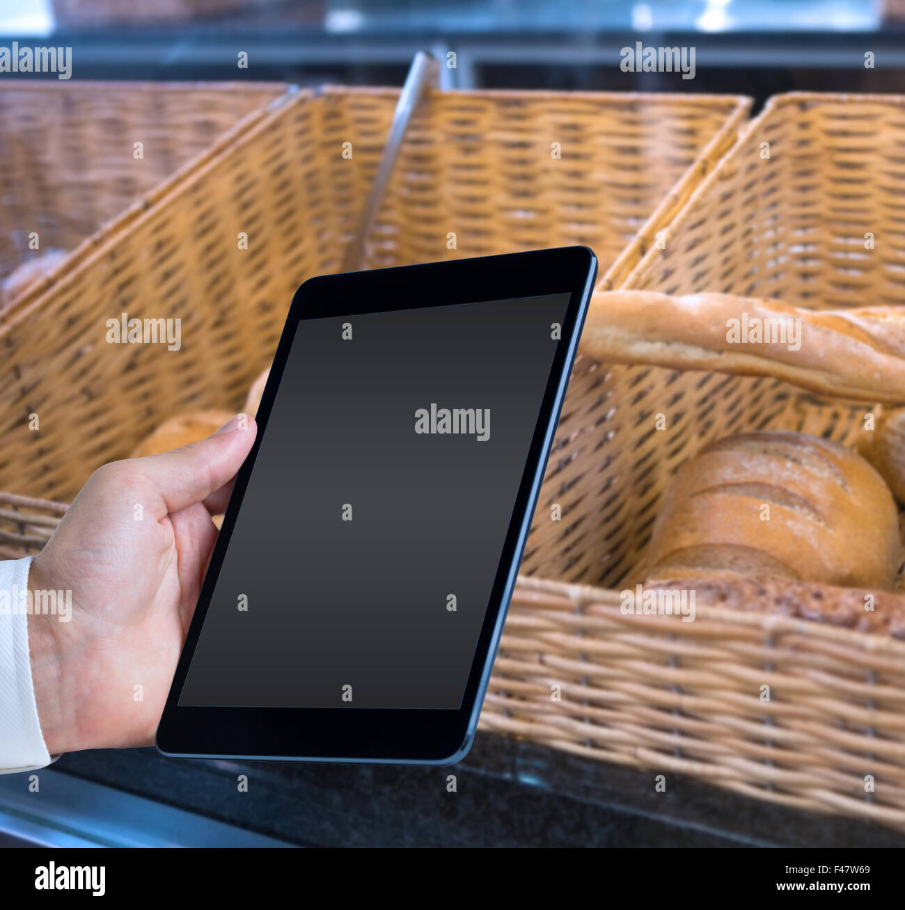 Composite image of man using tablet pc Stock Photo - Alamy