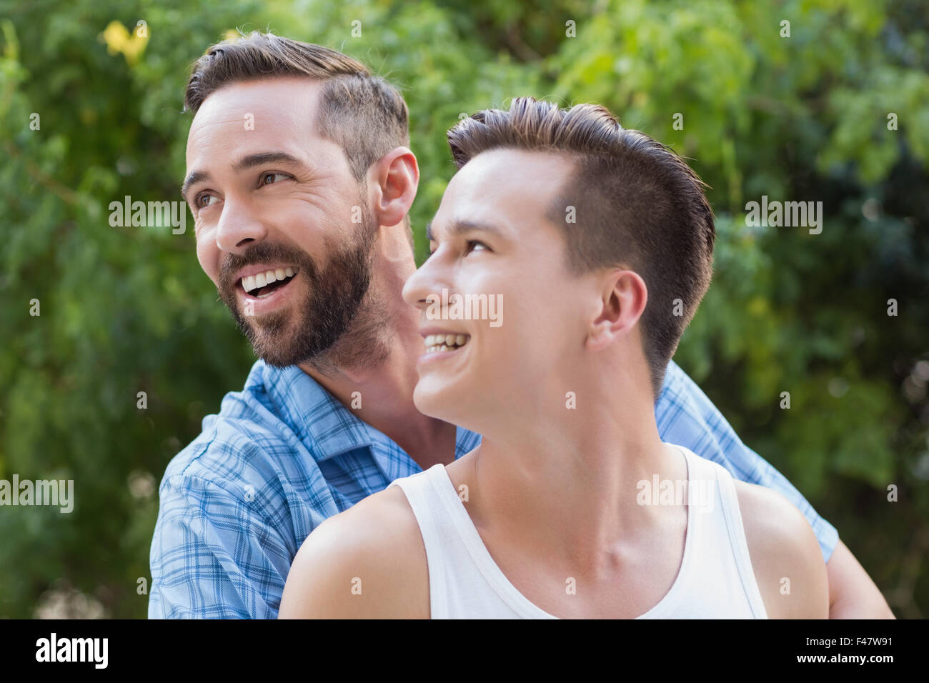 Happy homosexual couple looking away Stock Photo - Alamy