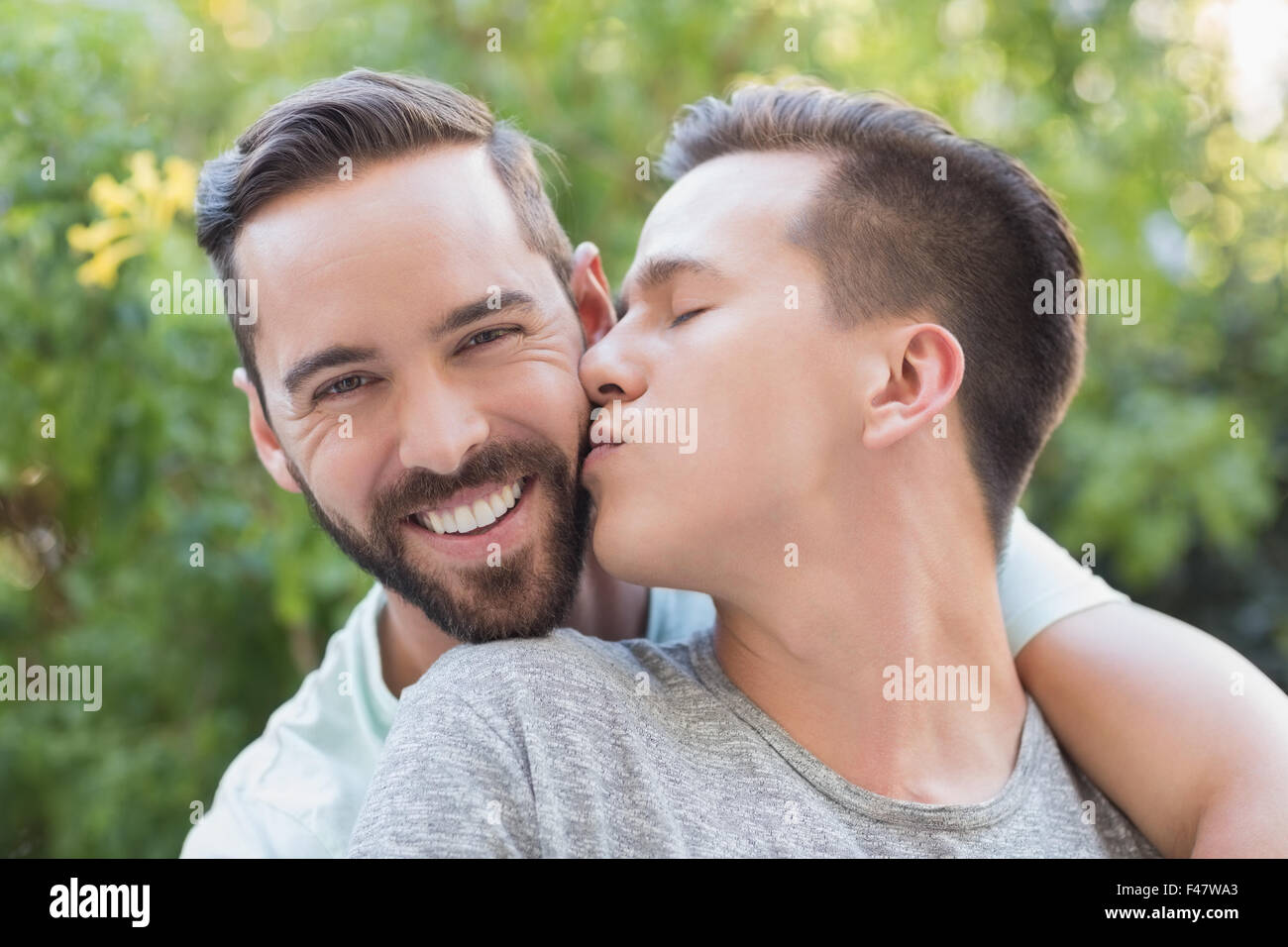 Handsome man kissing his boyfriend Stock Photo - Alamy