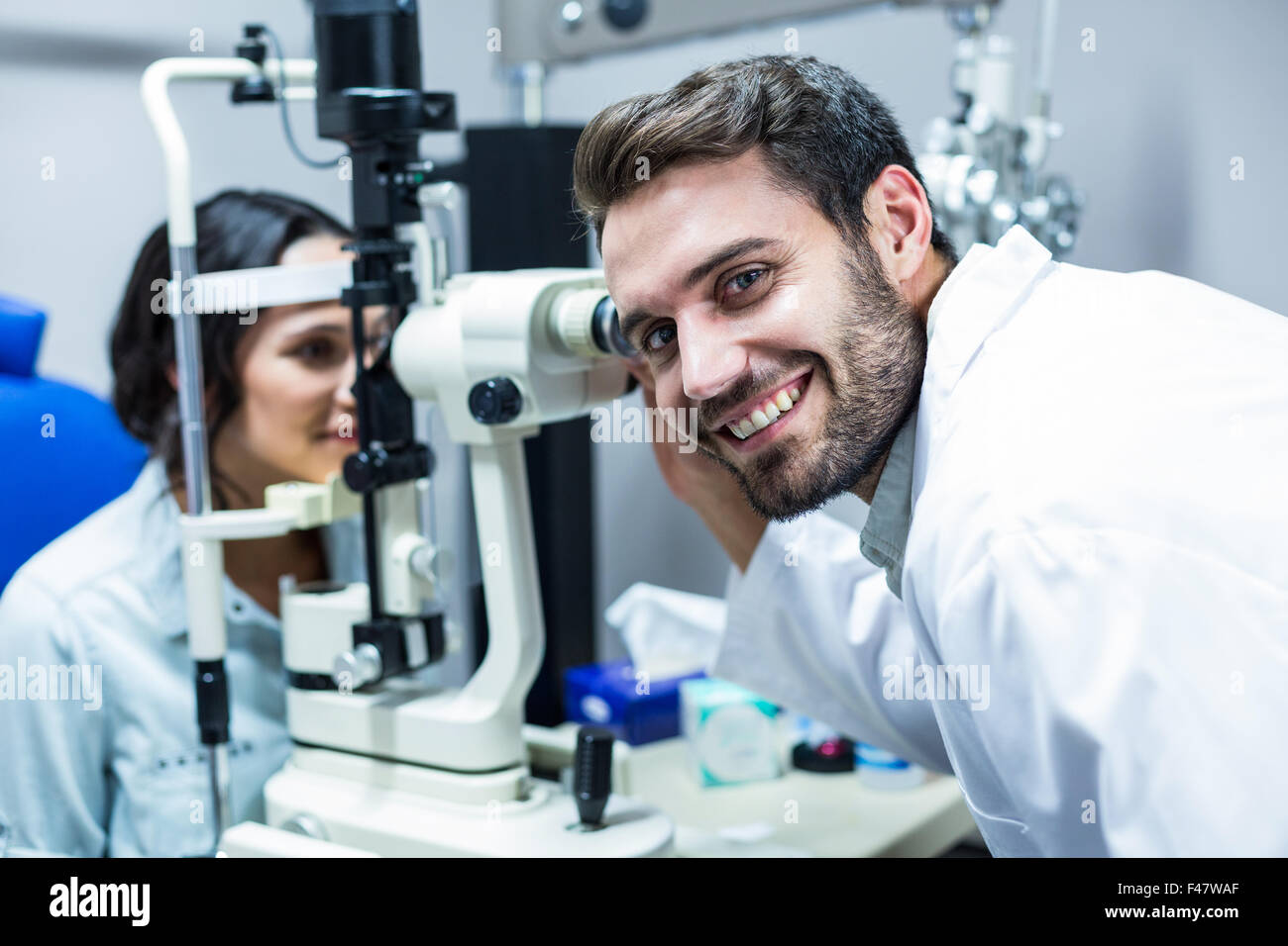 Happy optician and female patient with slit lamp Stock Photo - Alamy