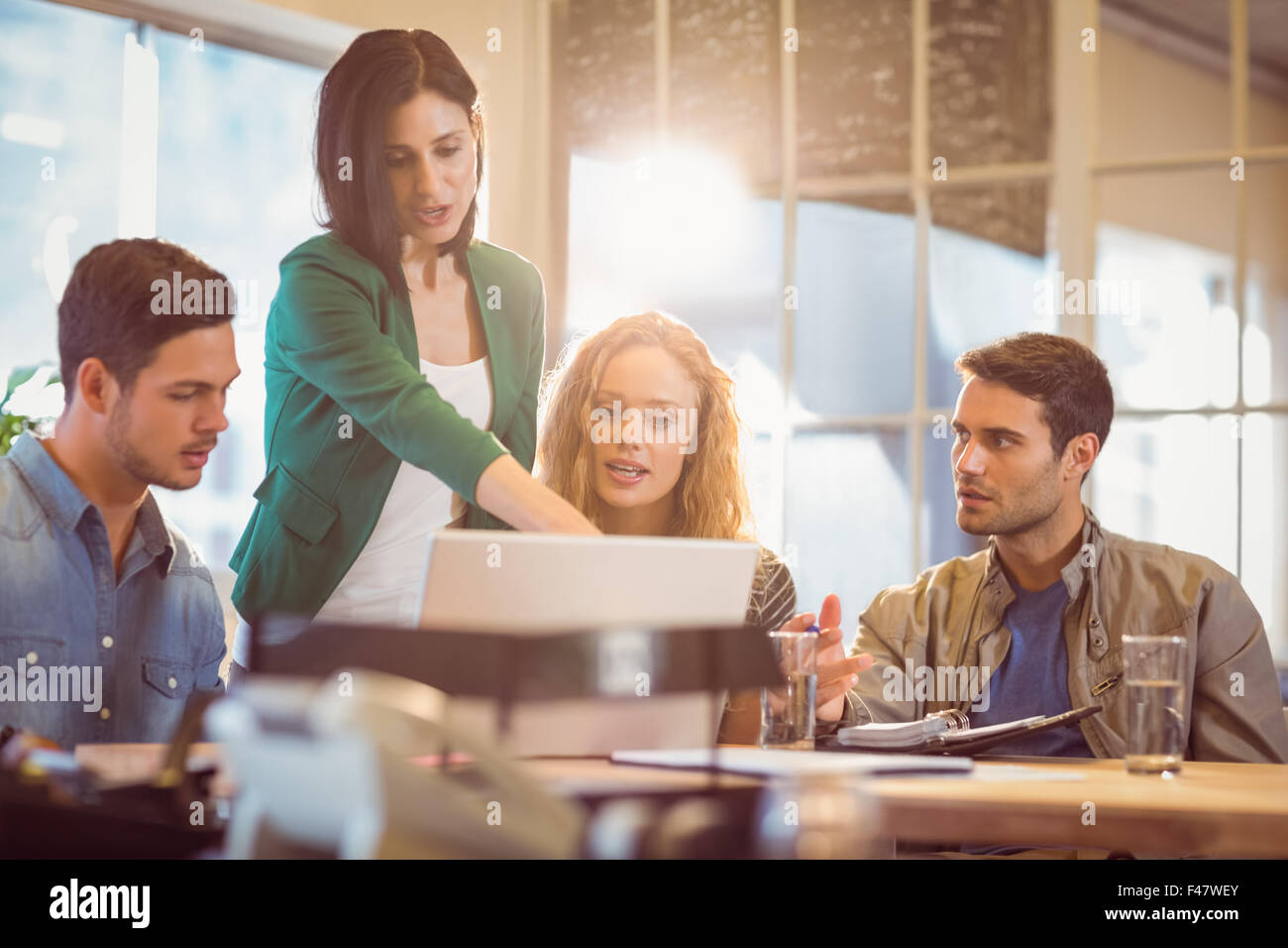 Group of young colleagues using laptop Stock Photo - Alamy