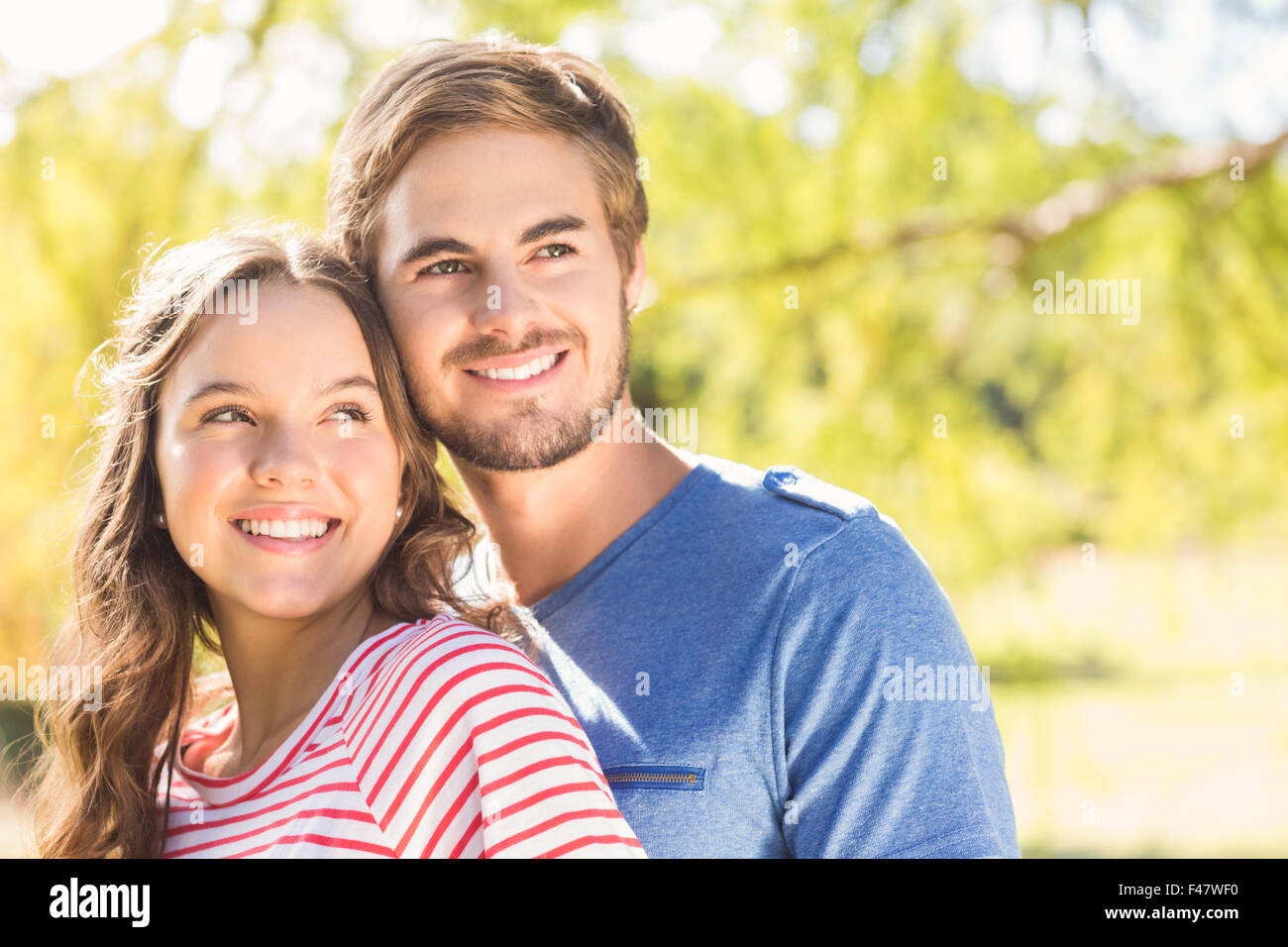 Cute couple hugging in the park Stock Photo - Alamy