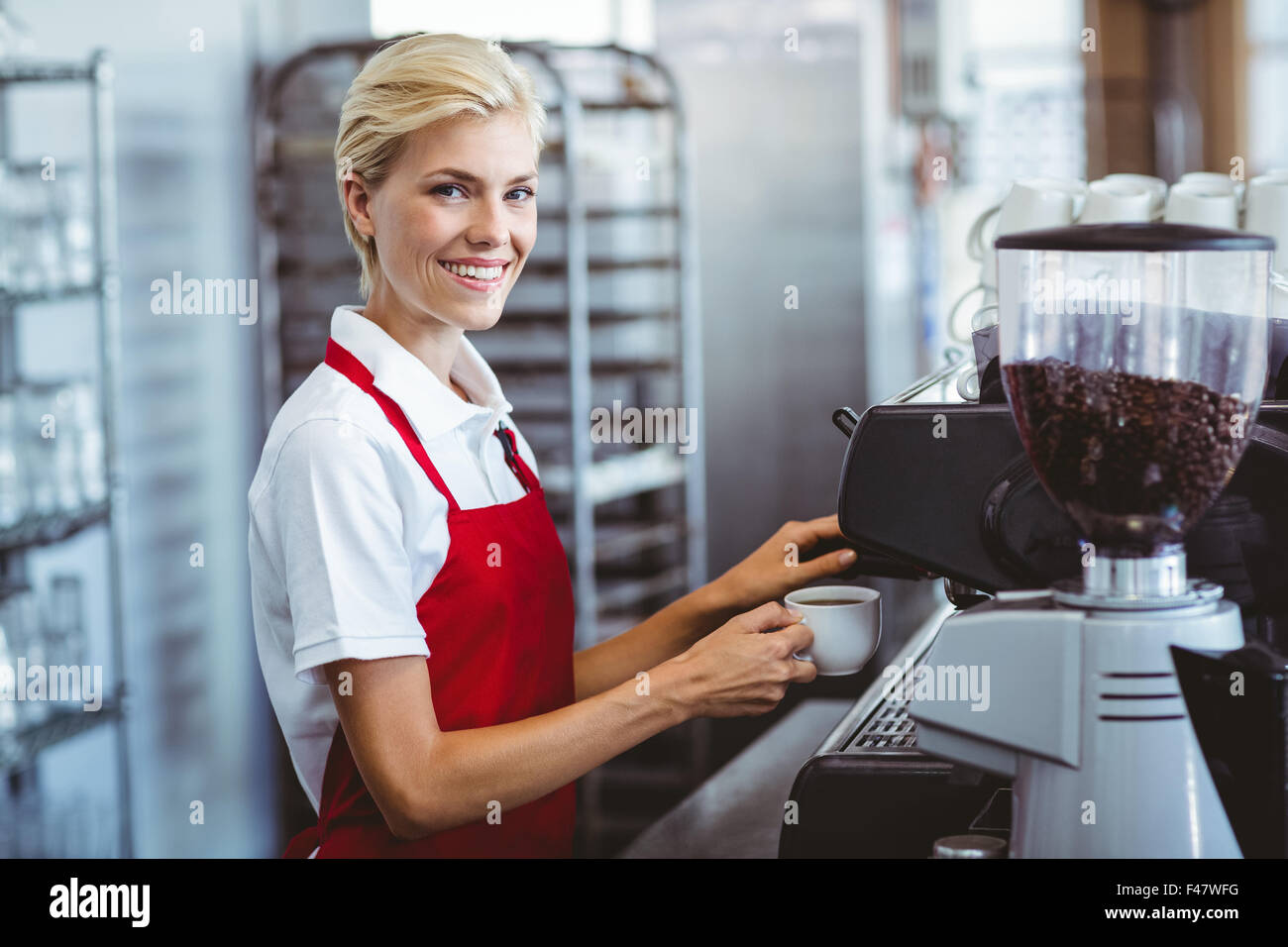 Pretty barista using the coffee machine Stock Photo - Alamy