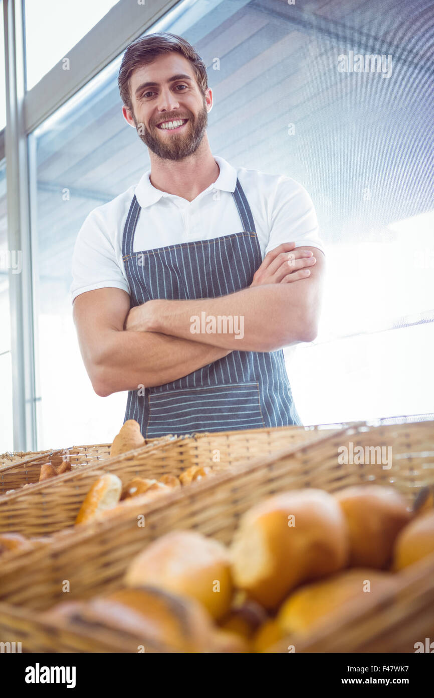 Smiling worker posing behind the counter Stock Photo - Alamy