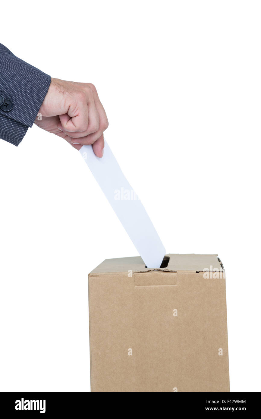 Businessman putting ballot in vote box Stock Photo - Alamy