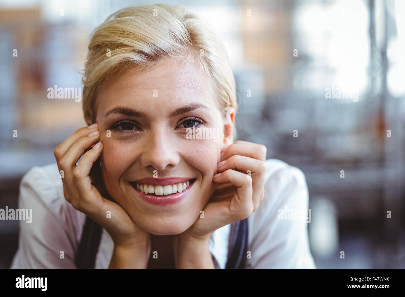 Selfassured female waitress smiling Stock Photo - Alamy