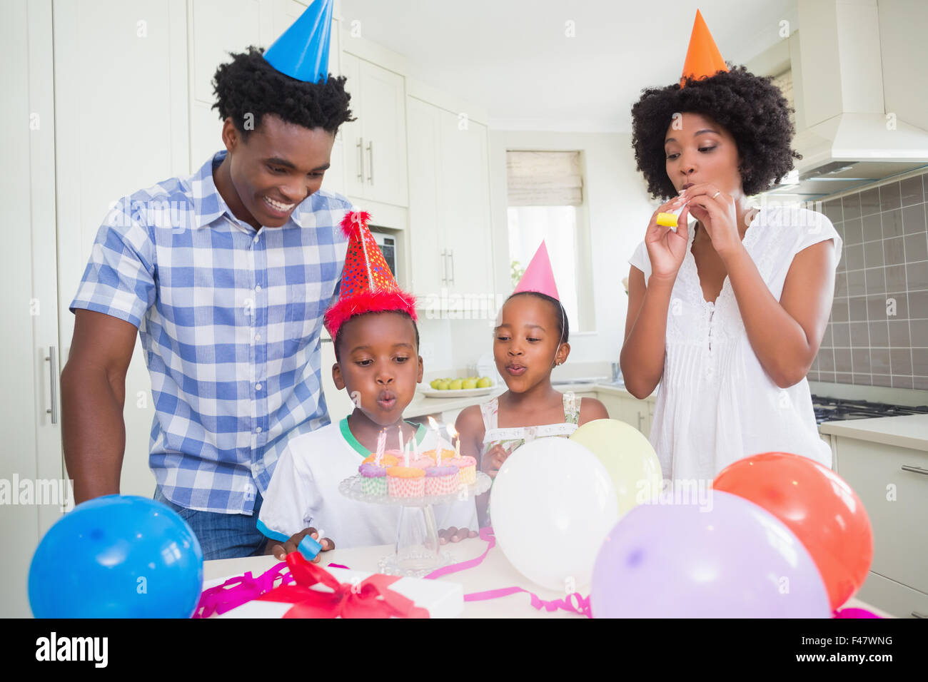 Happy family celebrating a birthday together Stock Photo - Alamy