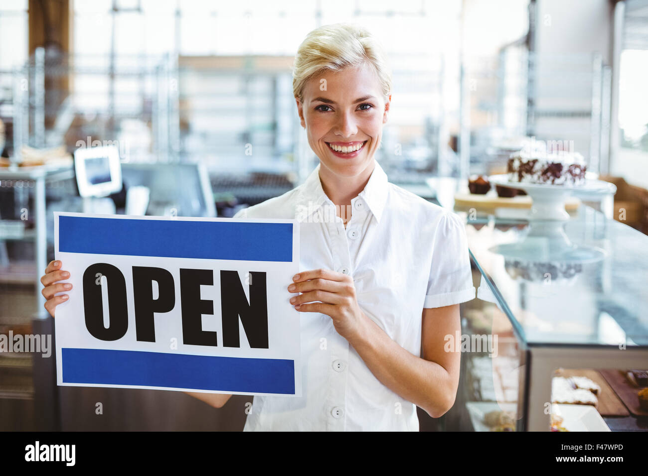 Cafe owner smiling at the camera Stock Photo - Alamy