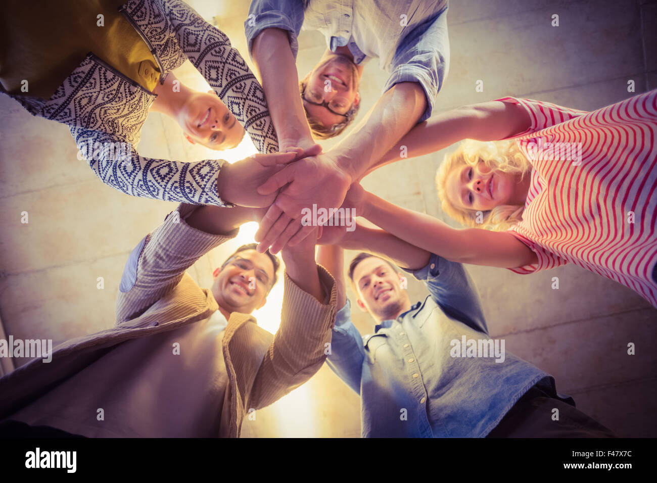 Happy business team joining hi-res stock photography and images - Alamy