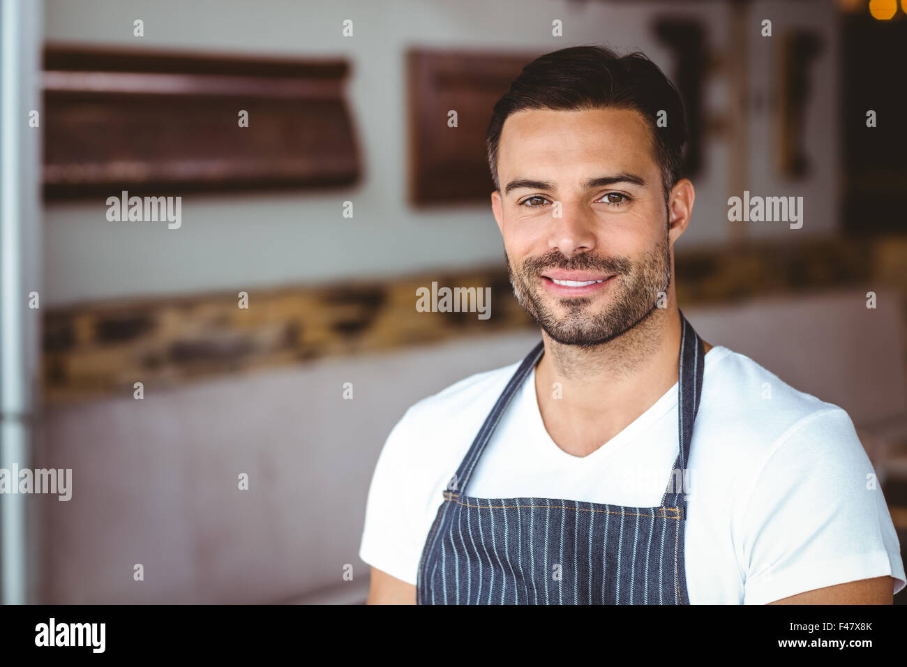 Handsome waiter smiling at camera Stock Photo - Alamy