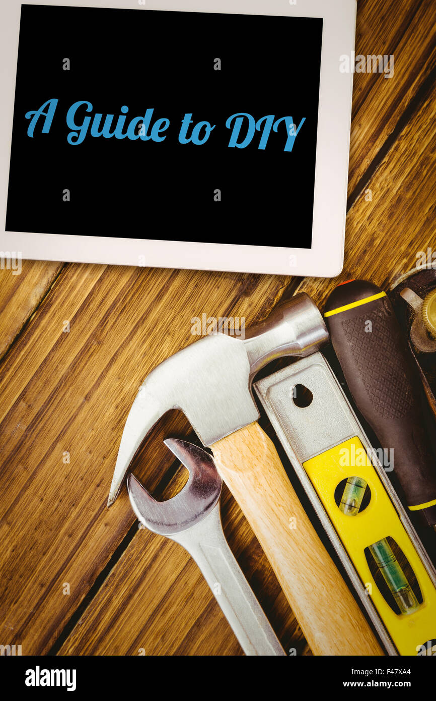 A guide to diy against desk with tools Stock Photo - Alamy