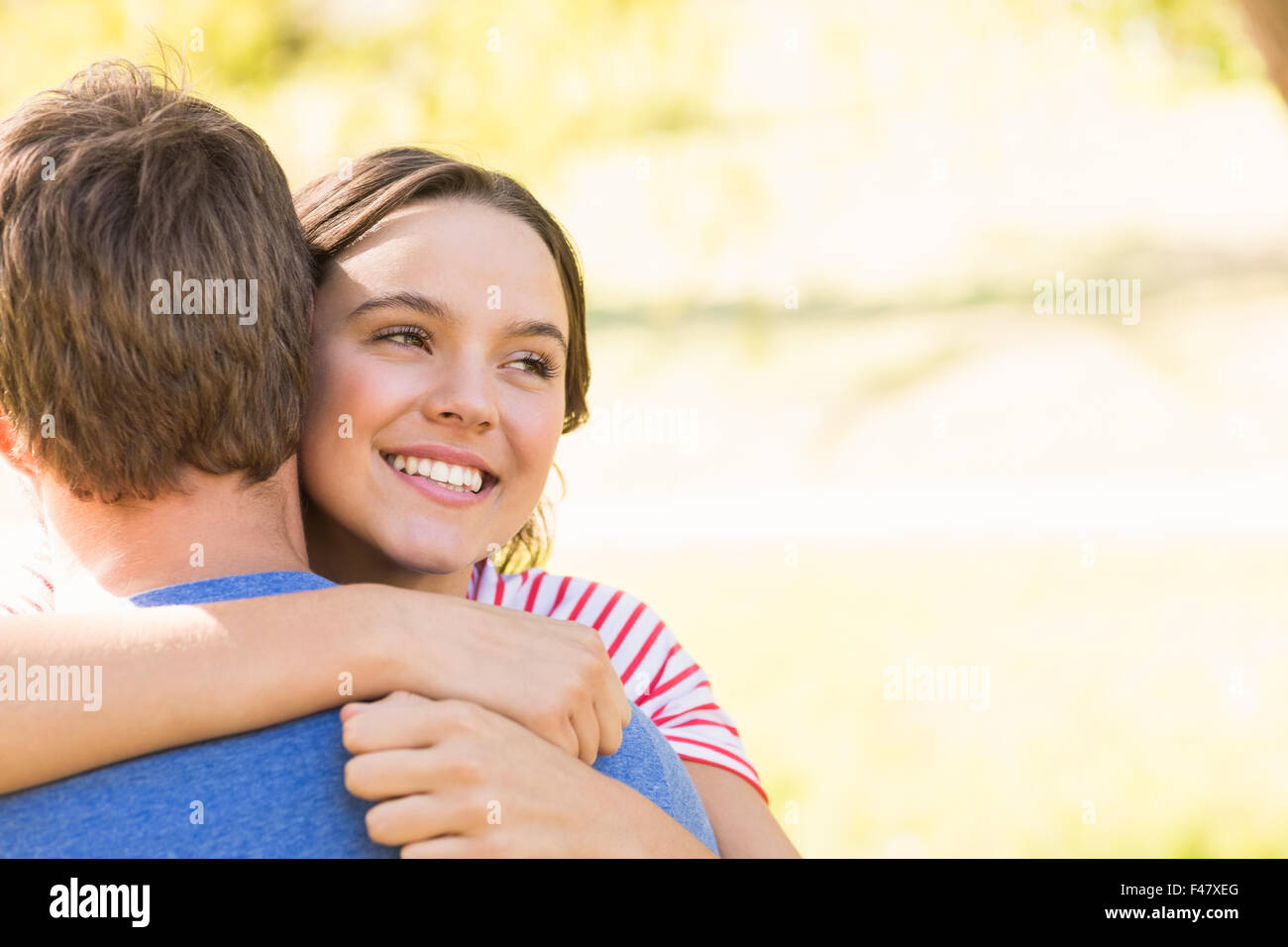 Cute couple hugging in the park Stock Photo - Alamy