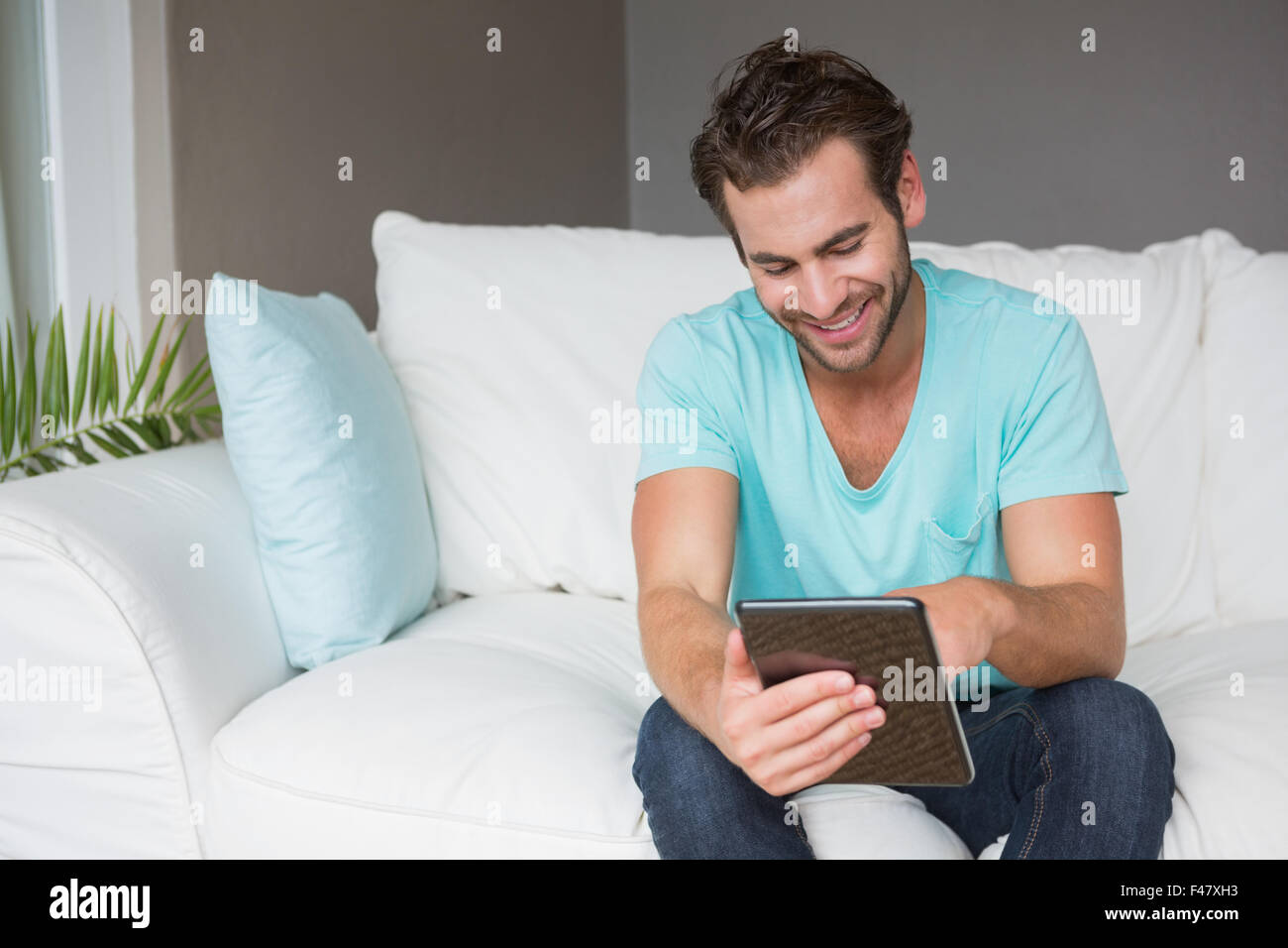 Happy handsome man tablet hi-res stock photography and images - Alamy