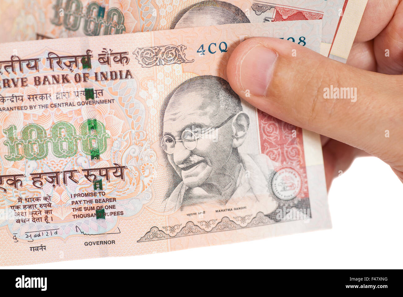 Hand with Indian thousand rupee notes isolated Stock Photo - Alamy