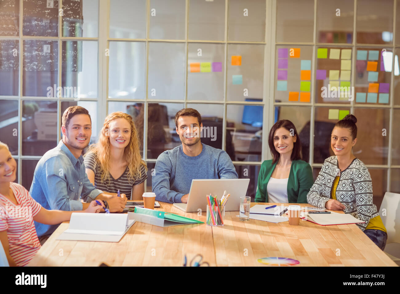 Group of young colleagues using laptop Stock Photo - Alamy
