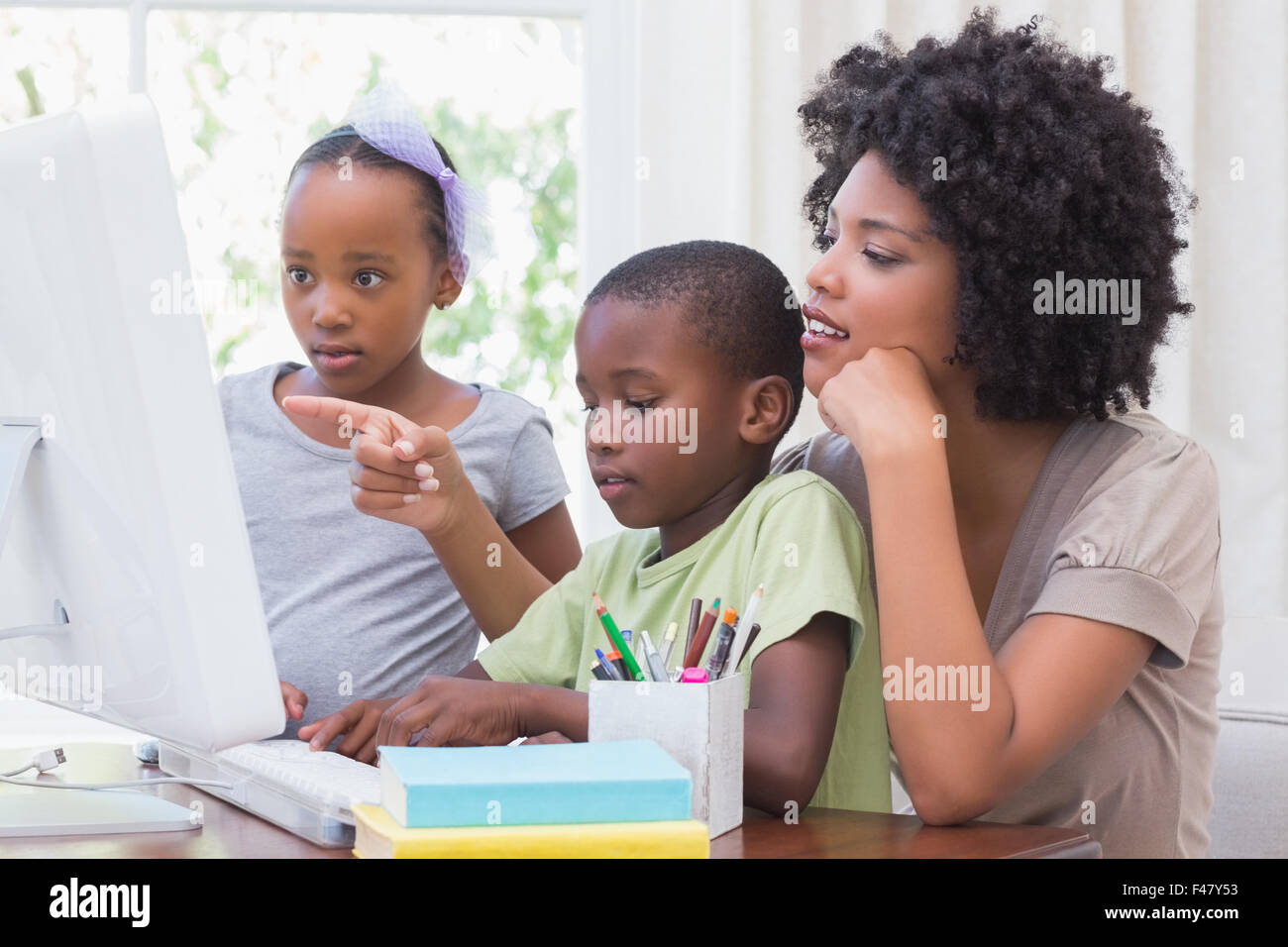 Happy family using the computer Stock Photo - Alamy