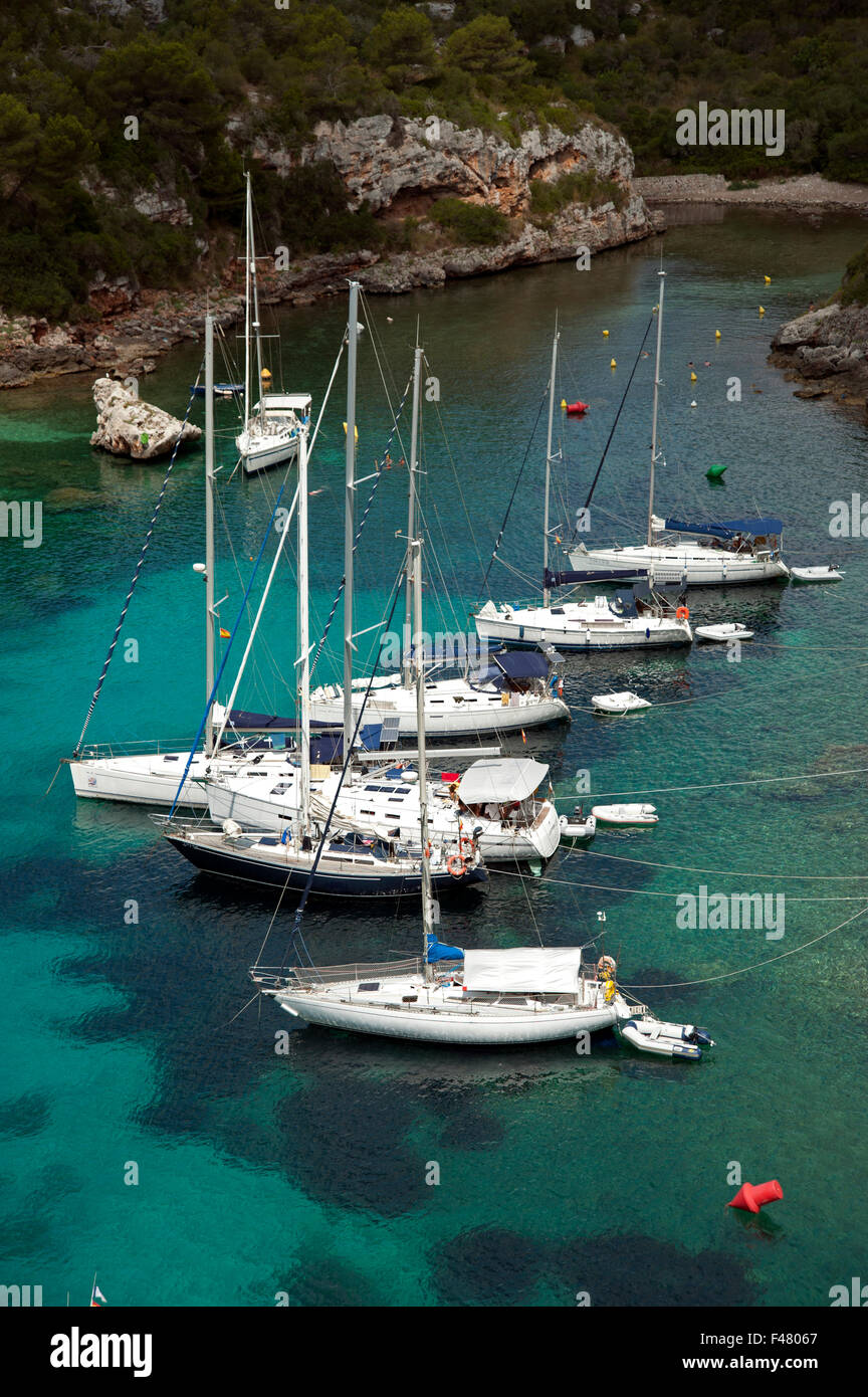 Sailing yachts moored in the secluded rocky cove of Calas Coves on the ...