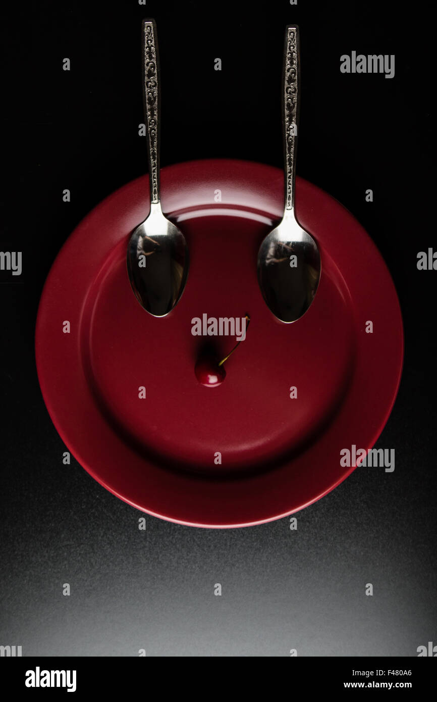 two spoons and a cherry Stock Photo - Alamy