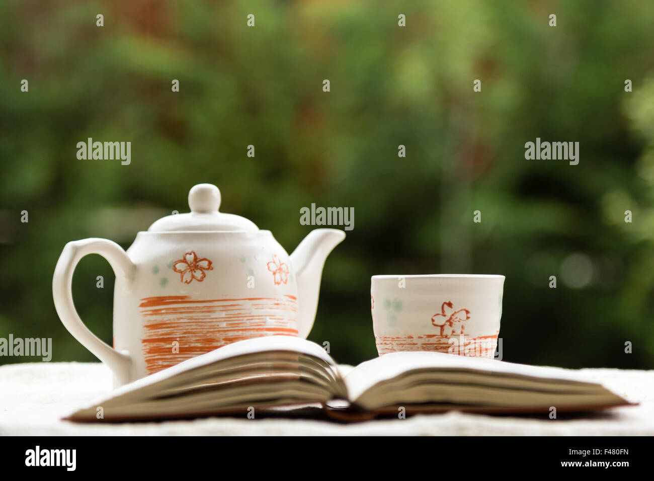 tea and book Stock Photo - Alamy