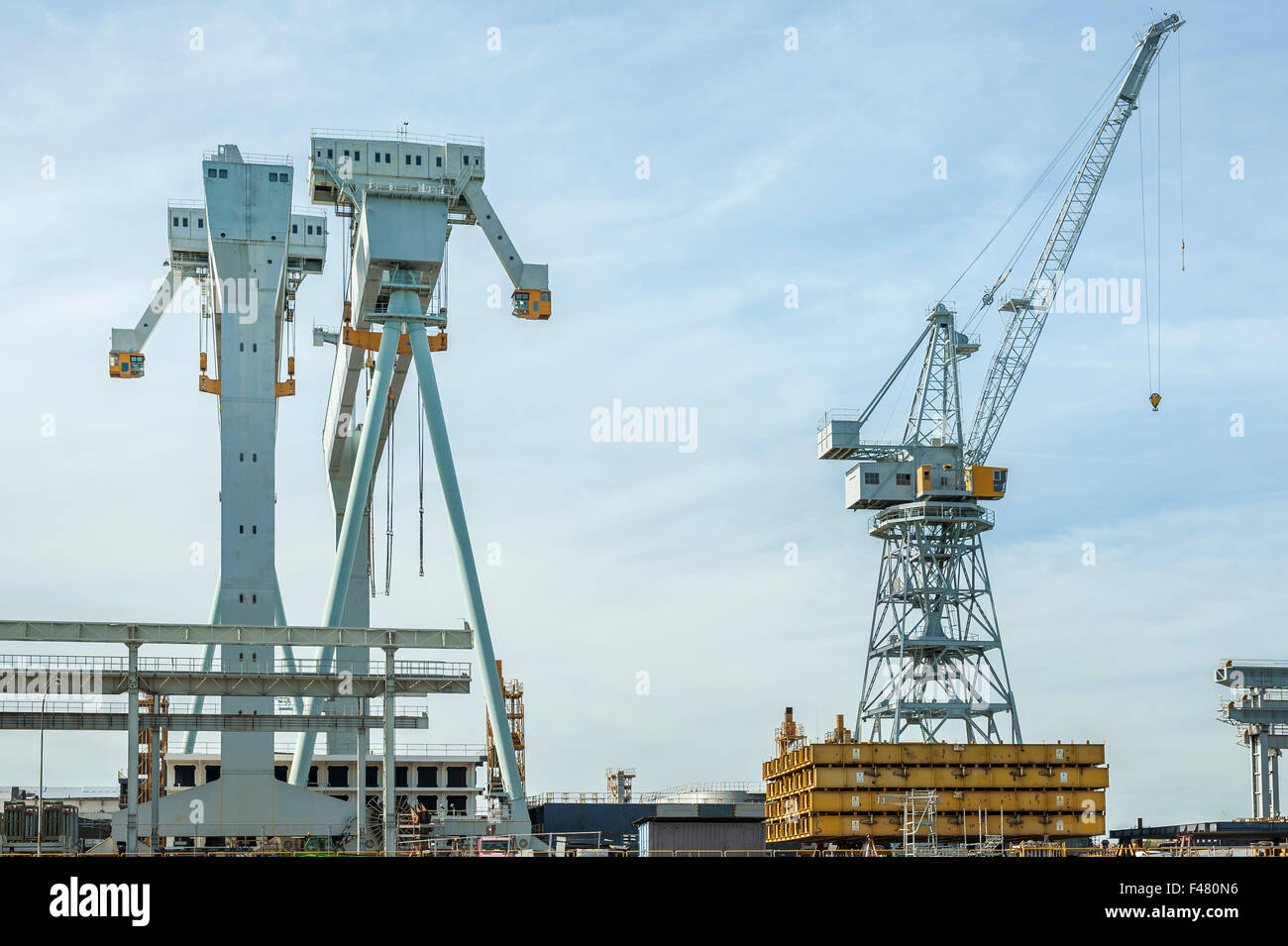 Various types of cranes at work in a shipyard Stock Photo - Alamy