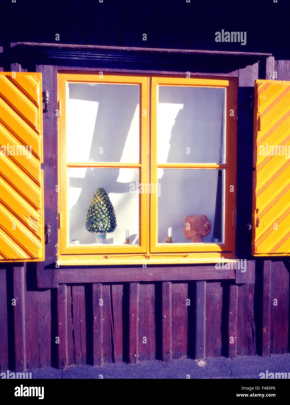 A yellow window and a purple house, Sweden Stock Photo - Alamy