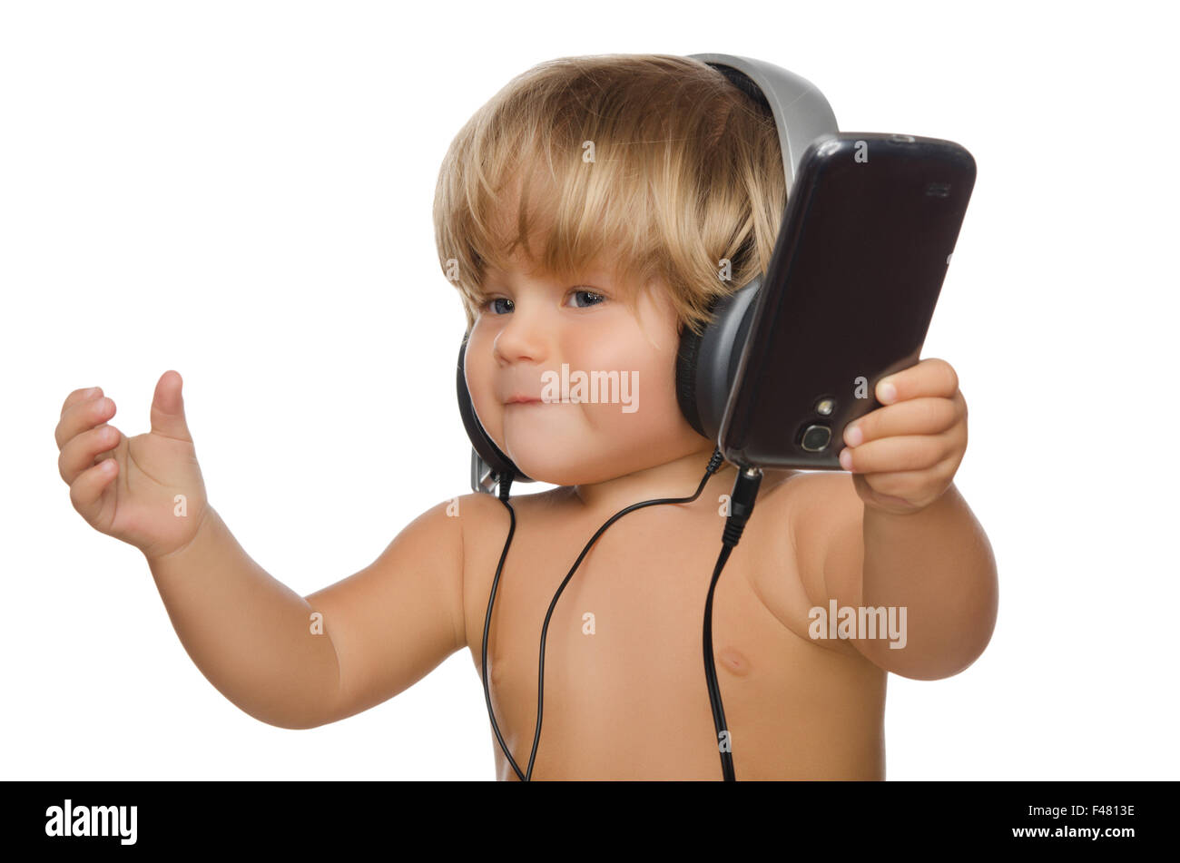 Smiling baby with headphones and smartphone Stock Photo - Alamy