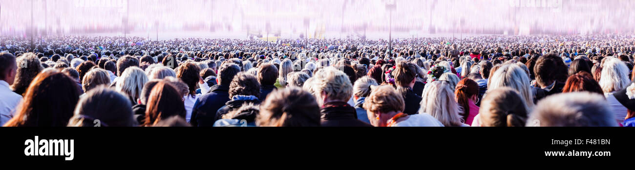 Panoramic photo of large crowd of people. Slow shutter speed motion ...