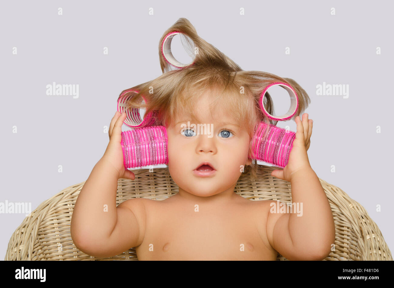 Little attractive girl with hair curlers Stock Photo - Alamy