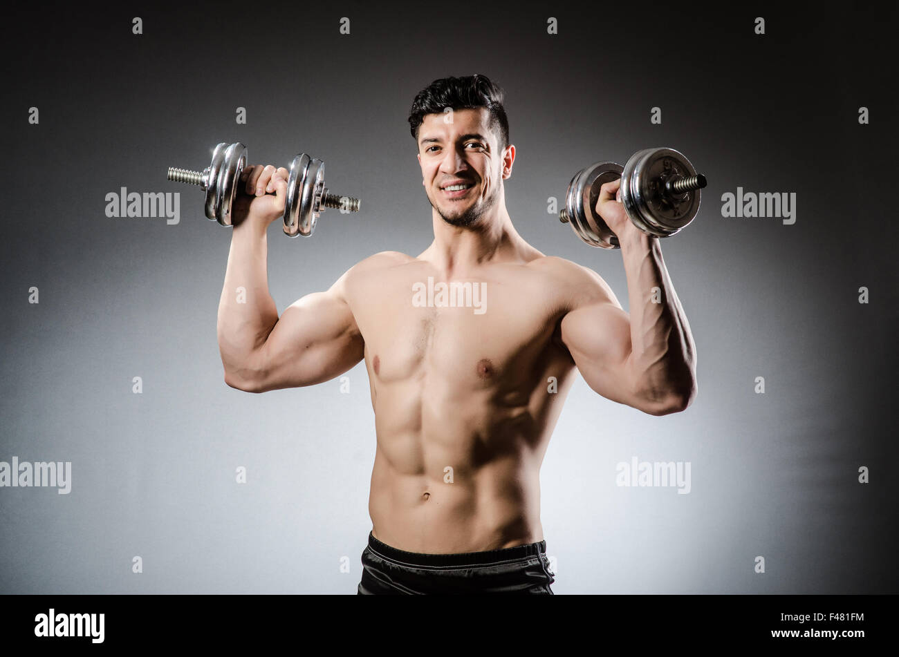 Muscular ripped bodybuilder with dumbbells Stock Photo - Alamy