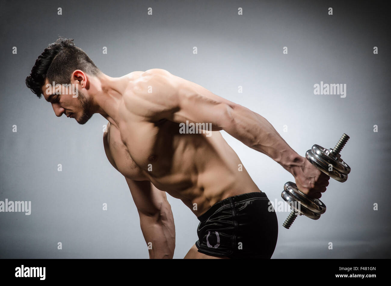 Muscular ripped bodybuilder with dumbbells Stock Photo - Alamy