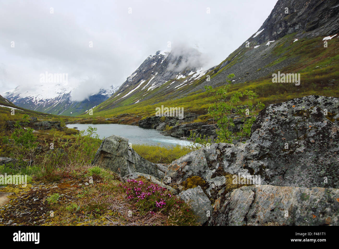 Beautiful spring Norway mountains and river with melting snow on tops ...