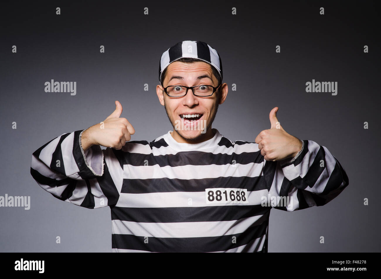 Funny prisoner isolated on gray Stock Photo - Alamy