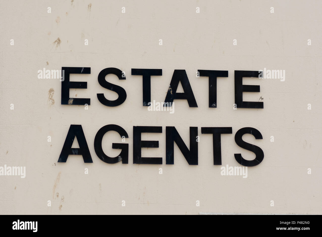 Estate Agents sign on wall of building Stock Photo - Alamy