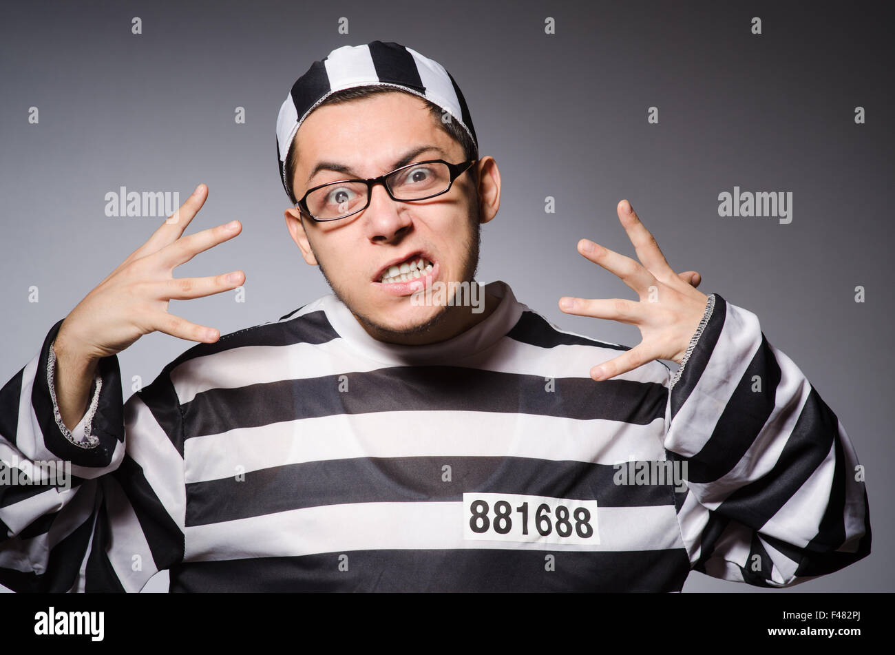 Funny prisoner isolated on gray Stock Photo - Alamy