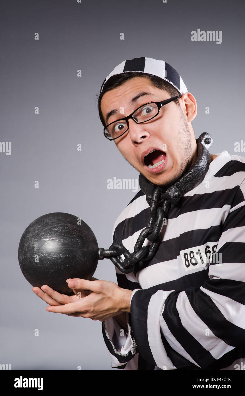 Funny prisoner in chains isolated on gray Stock Photo - Alamy