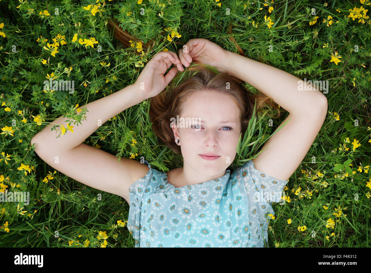 Teen girl lying in field hi-res stock photography and images - Alamy