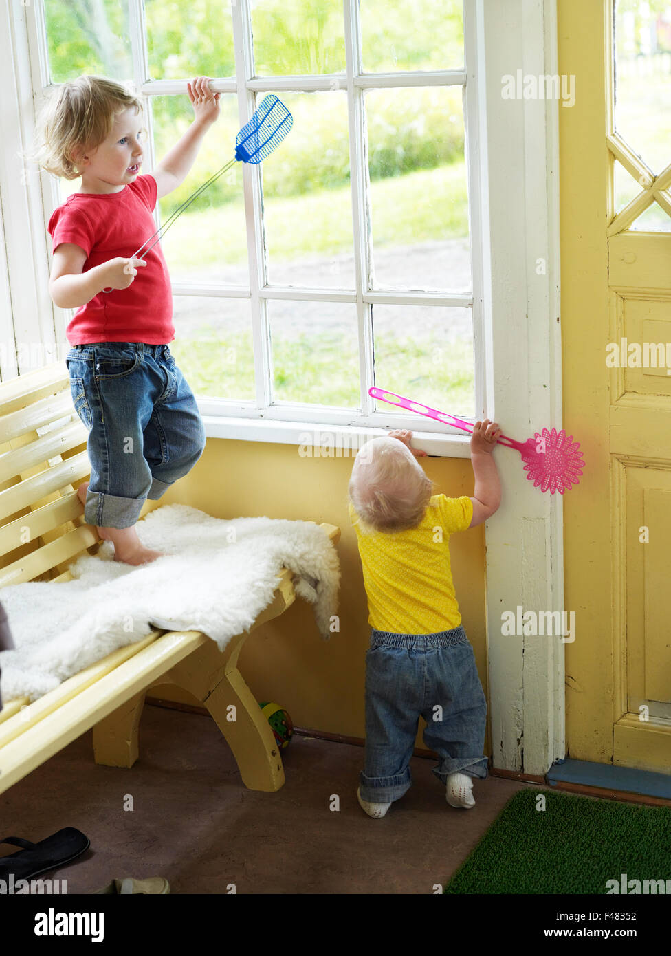 Children playing with a fly-flap, Sweden Stock Photo - Alamy