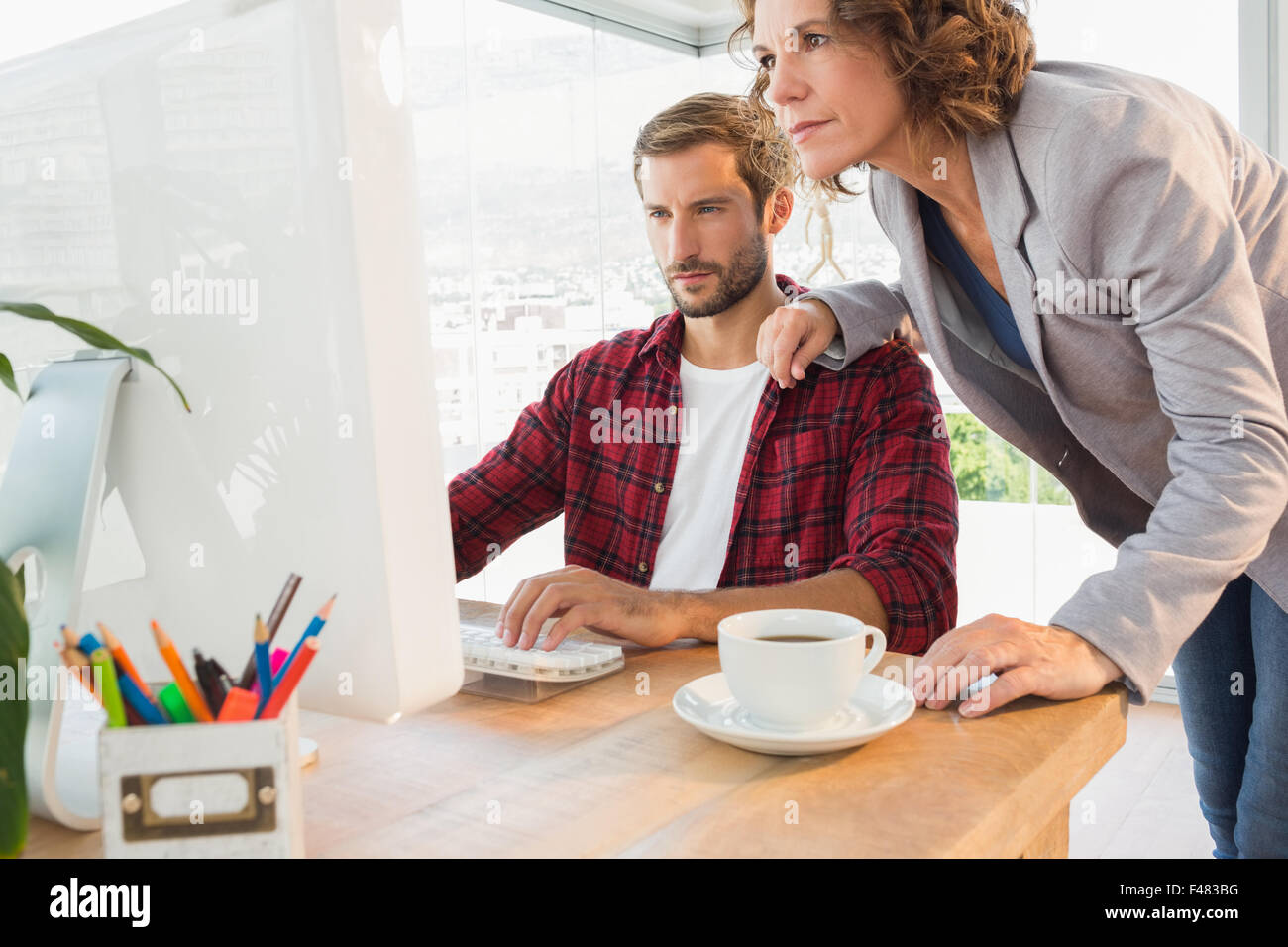 Creative business people working together on computer Stock Photo - Alamy
