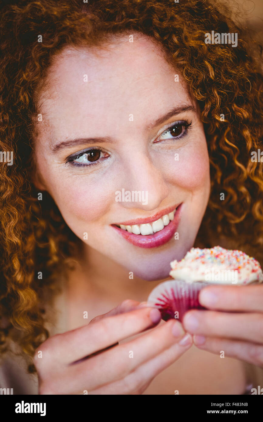 Portrait of a happy pretty woman eating a cake Stock Photo - Alamy