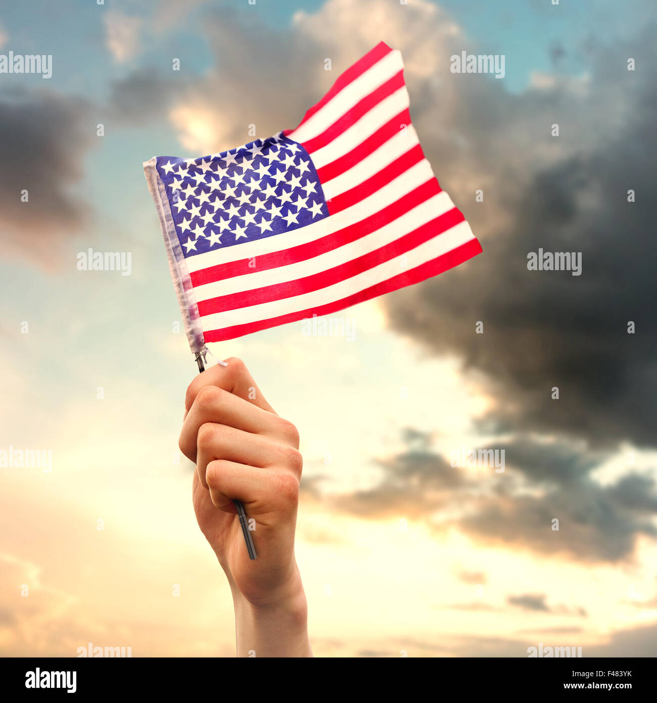 Composite image of hand waving american flag Stock Photo - Alamy