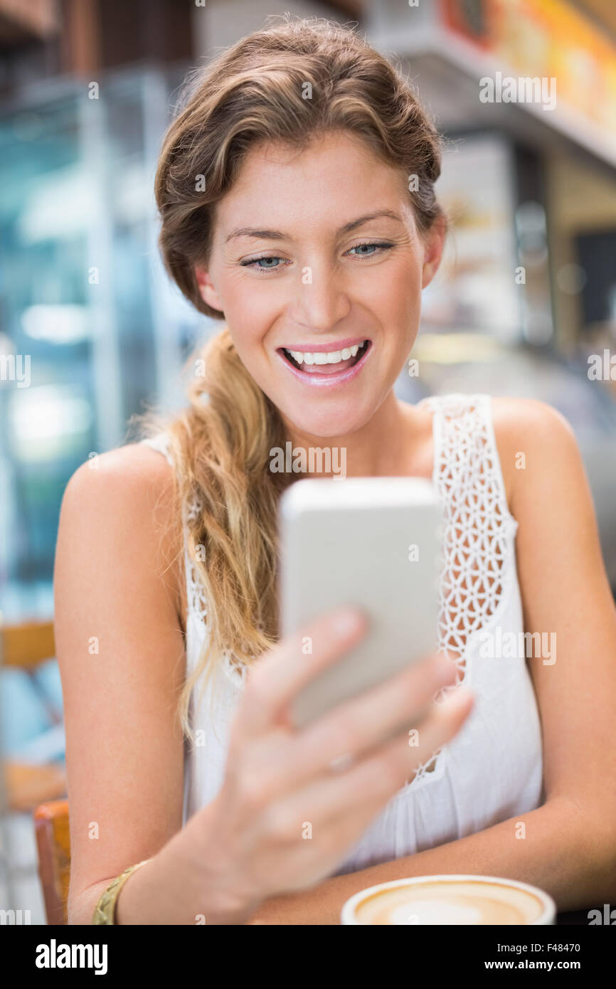 Beautiful woman looking phone smiling hi-res stock photography and ...