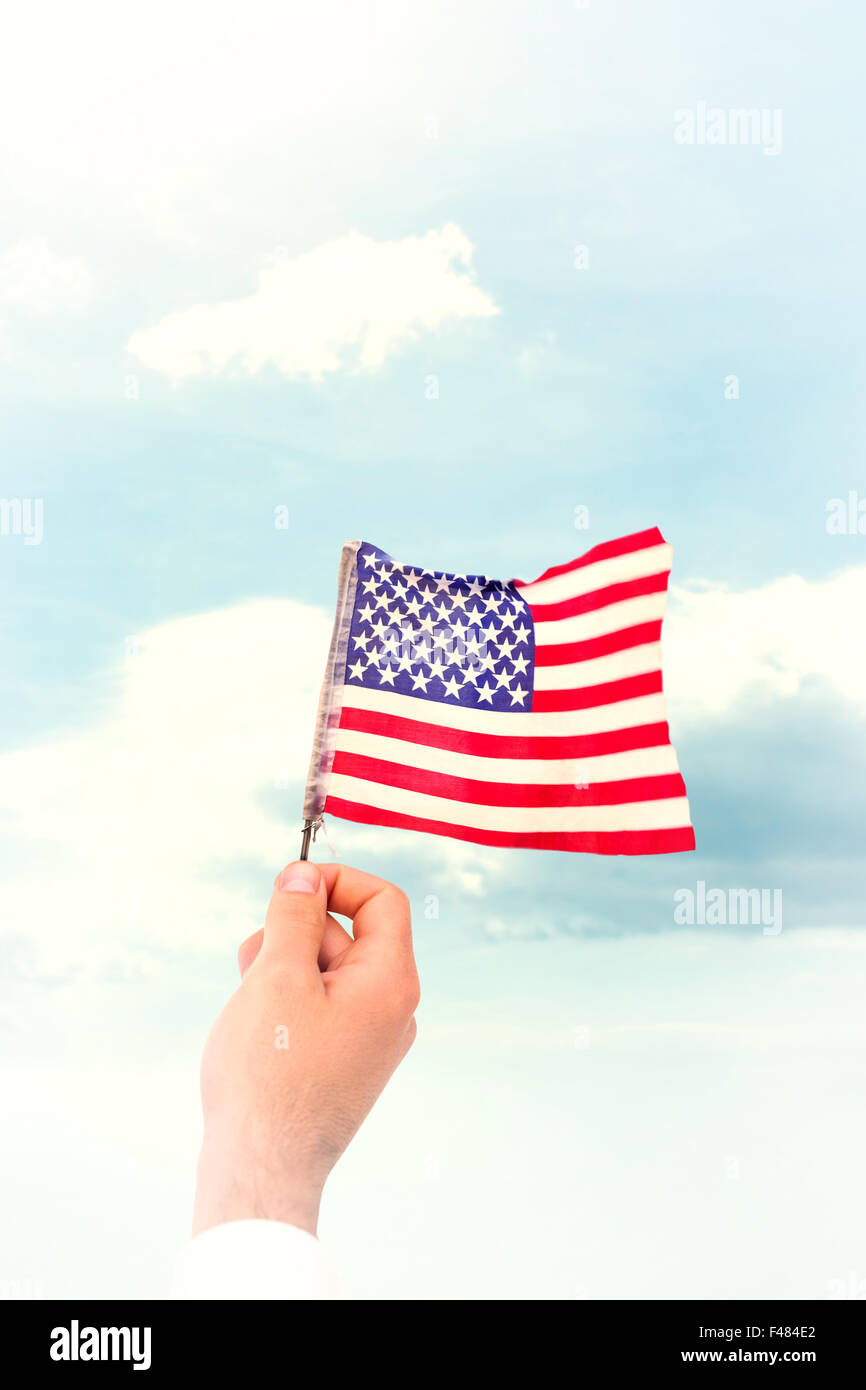 Composite image of hand waving american flag Stock Photo - Alamy