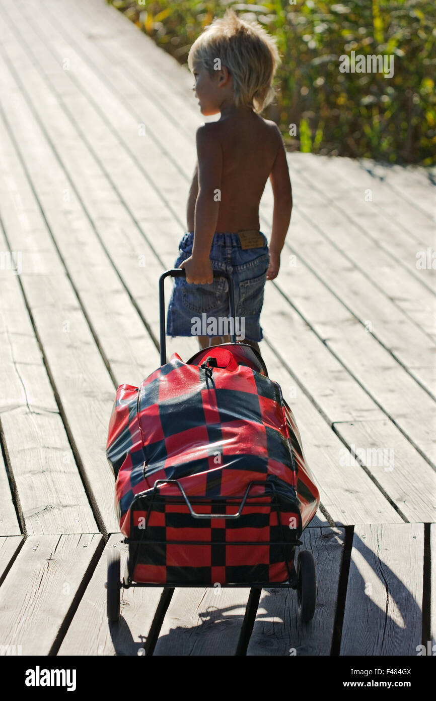 Dragging heavy bag hi-res stock photography and images - Alamy